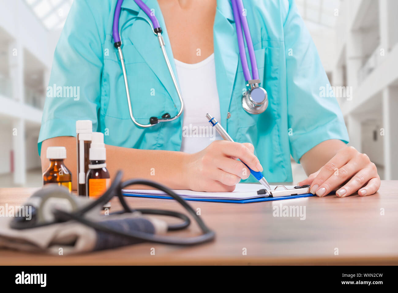 Doctor hand writing prescription using hi-res stock photography and ...