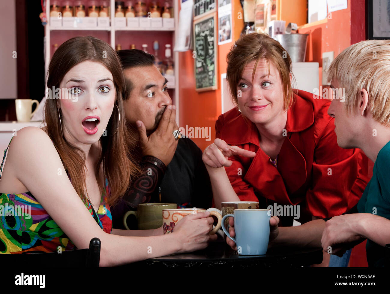 Four friends having an animated discussion in a coffee house Stock ...
