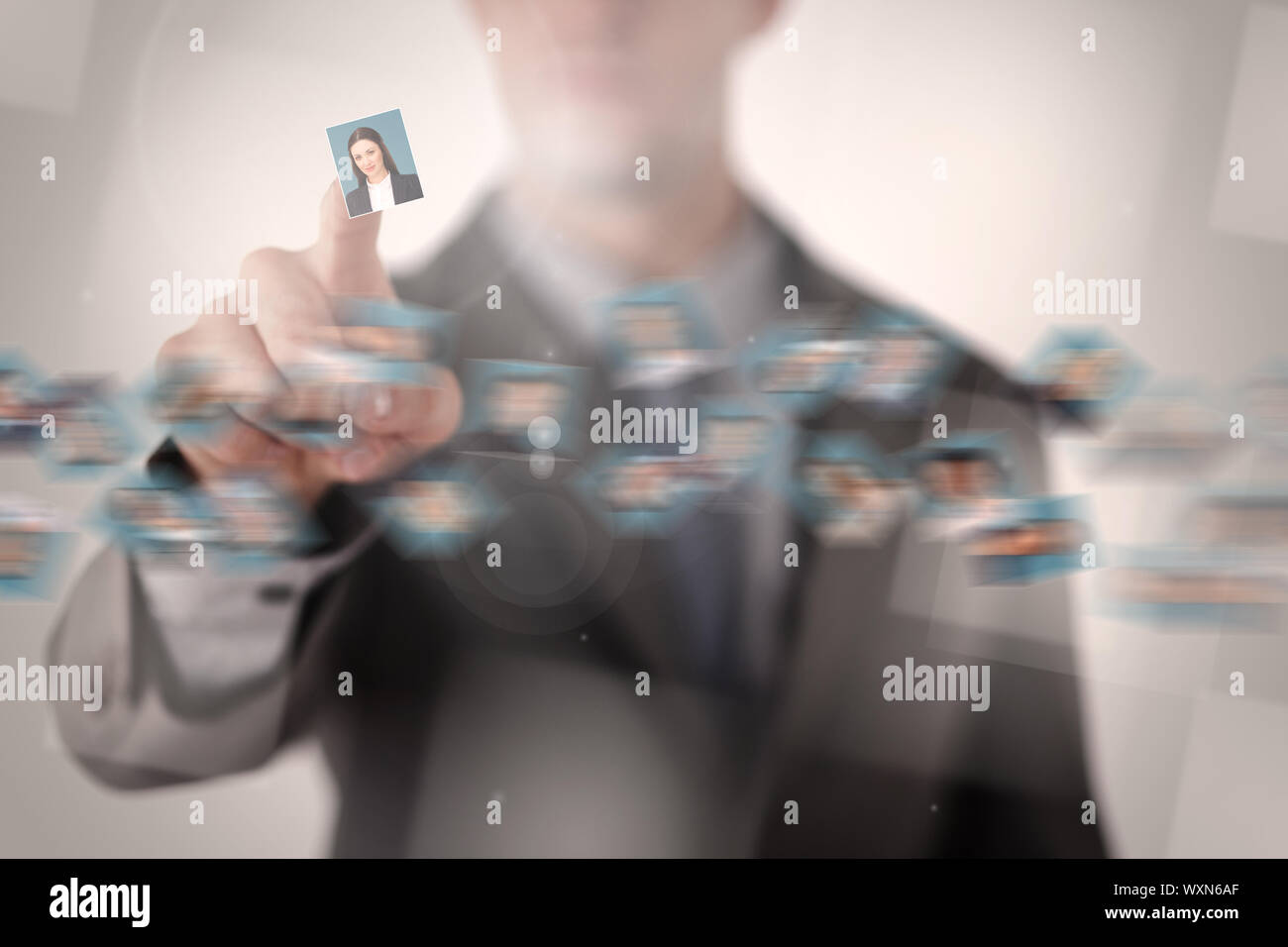 A businessman's hand touching something against a white background ...