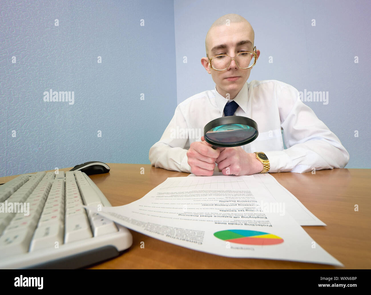 The boss with a magnifier in a hand on a workplace Stock Photo - Alamy