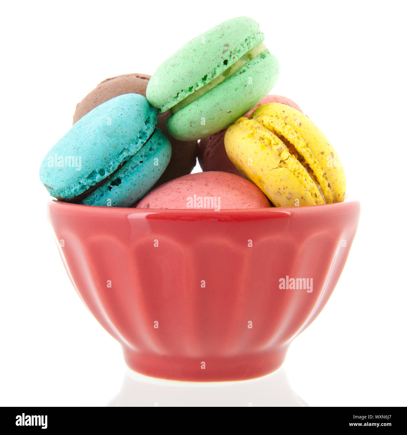 Colorful French macaroons in bowl isolated over white background Stock ...