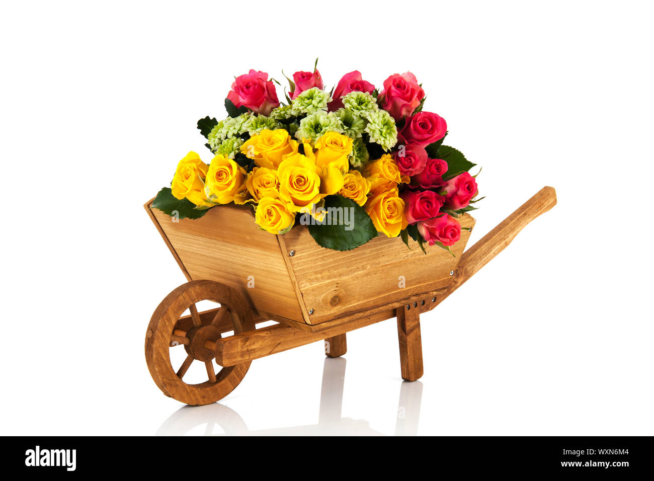 Wooden wheel barrow with colorful flowers Stock Photo - Alamy