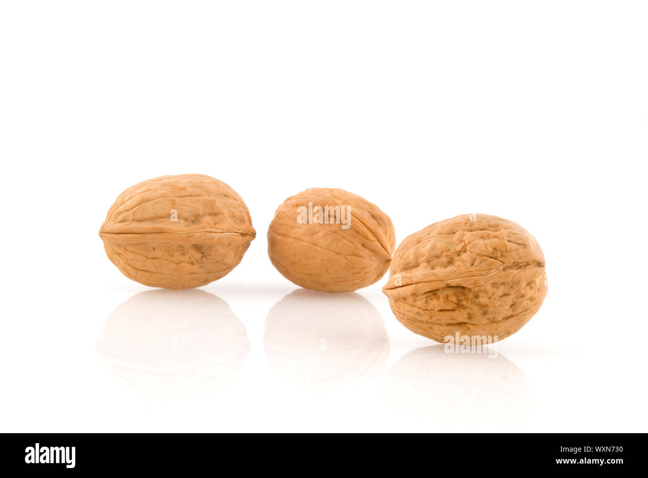 three walnuts on a white background Stock Photo - Alamy