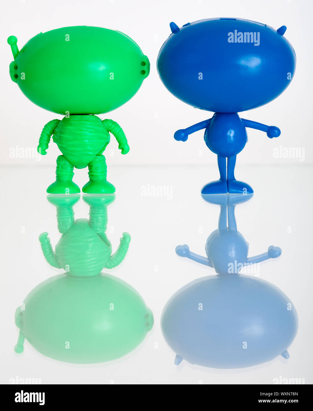 Two figures of aliens on a white background Stock Photo - Alamy