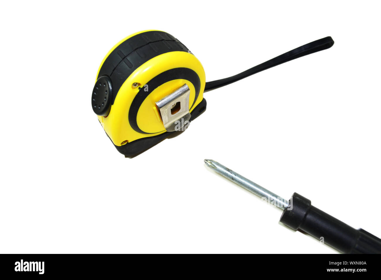 Yellow tape measure on white Stock Photo - Alamy