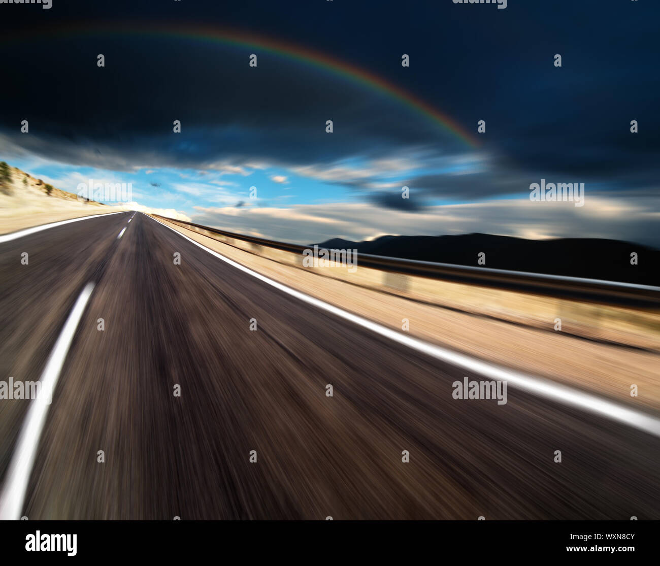 Road in desert with motion blur and storm clouds Stock Photo - Alamy
