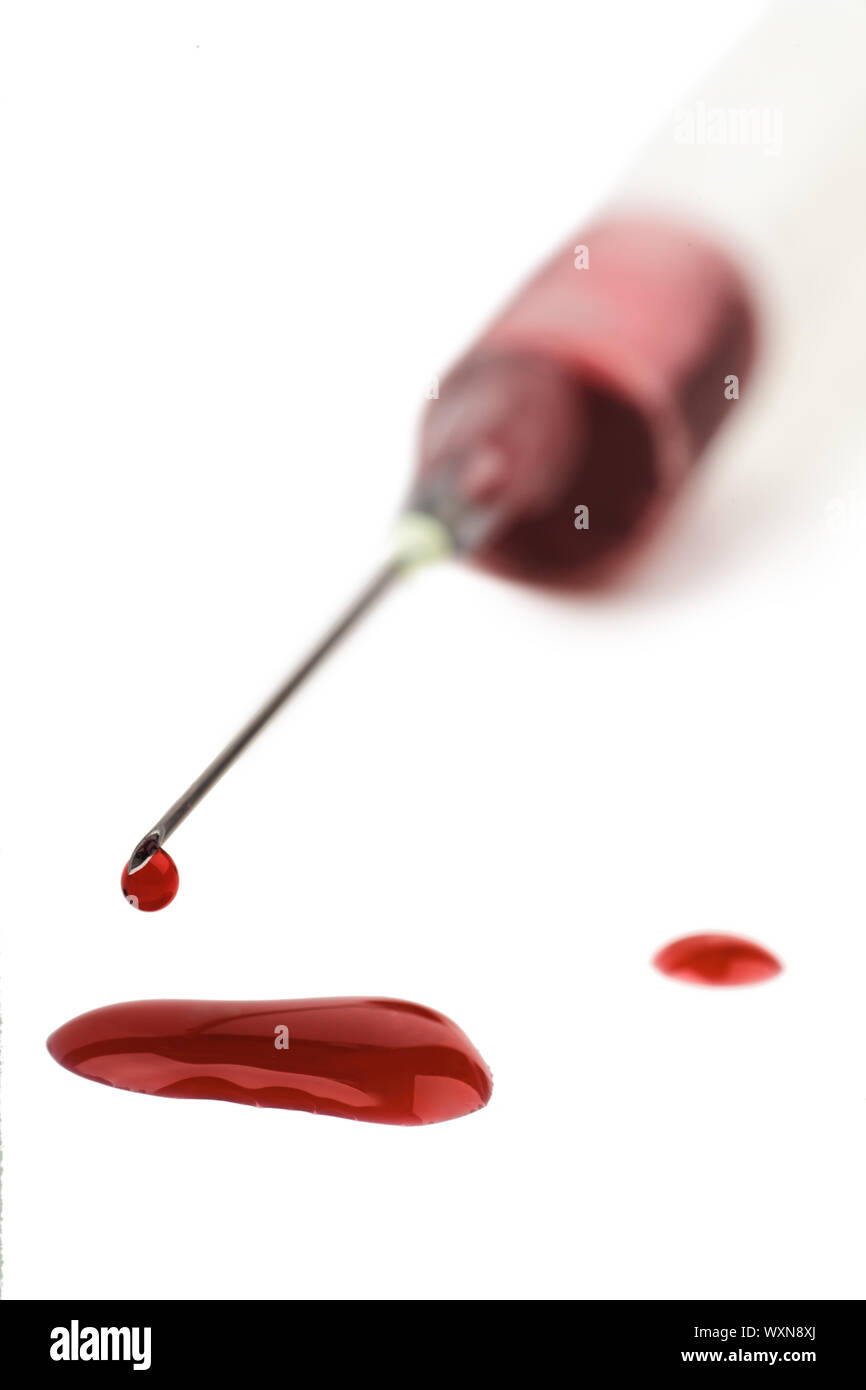 Macro view of drop of blood from syringe over white background Stock ...