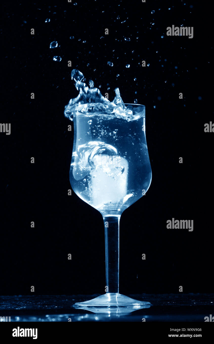 alcohol splash on black background Stock Photo - Alamy