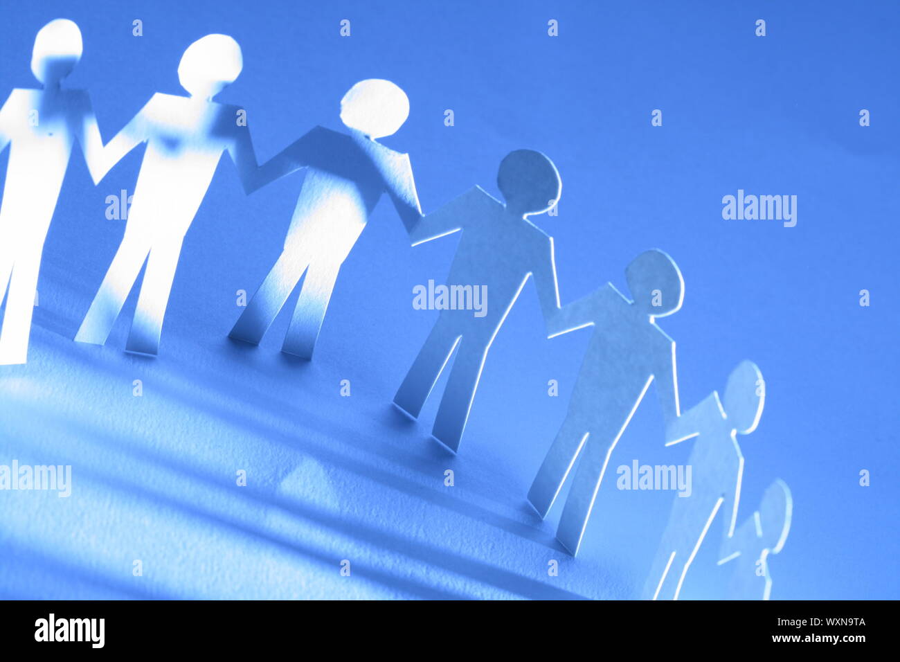 paper team linked together partnership concept Stock Photo - Alamy