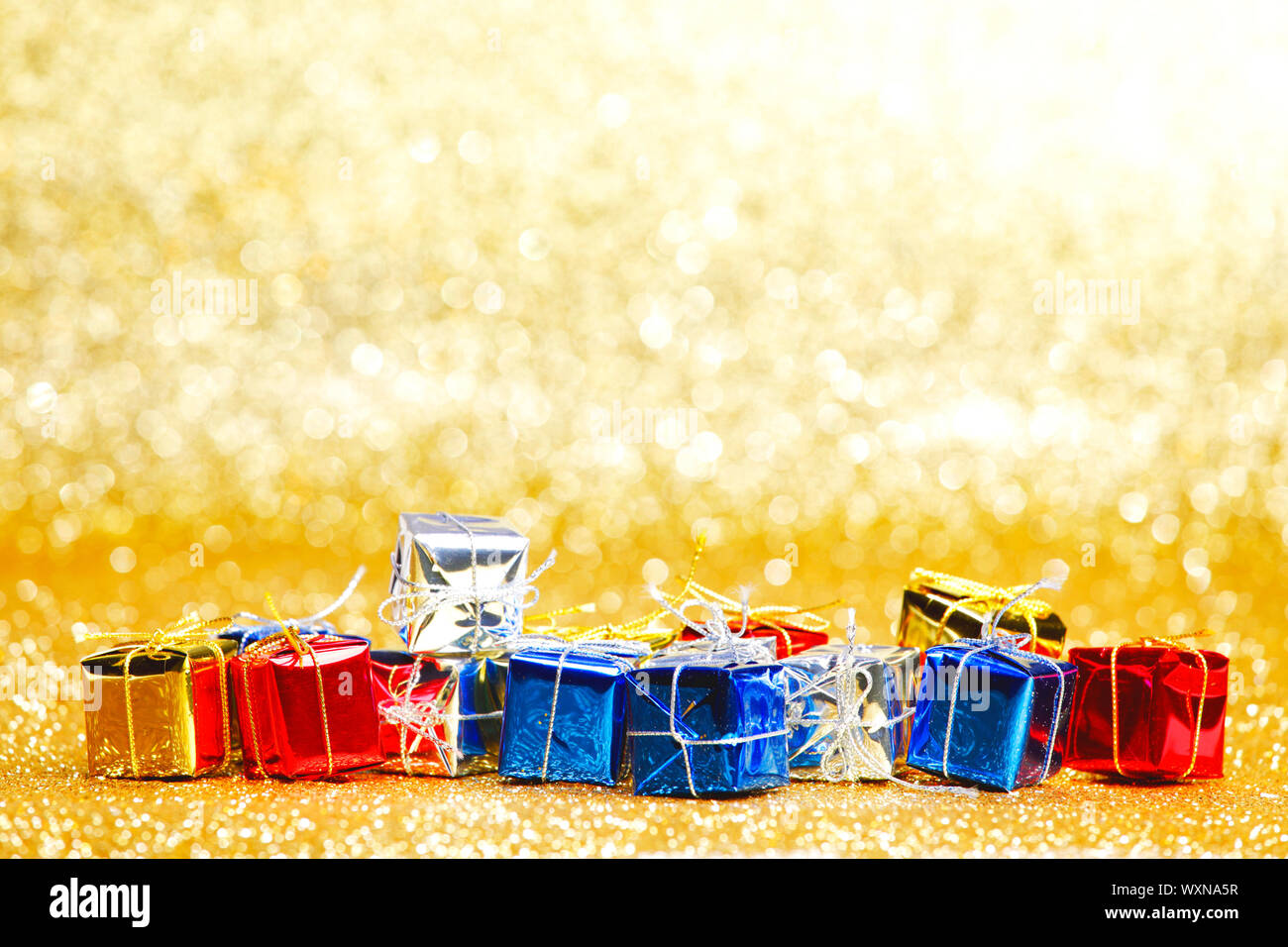 Colorful gift boxes on glitter golden background Stock Photo - Alamy