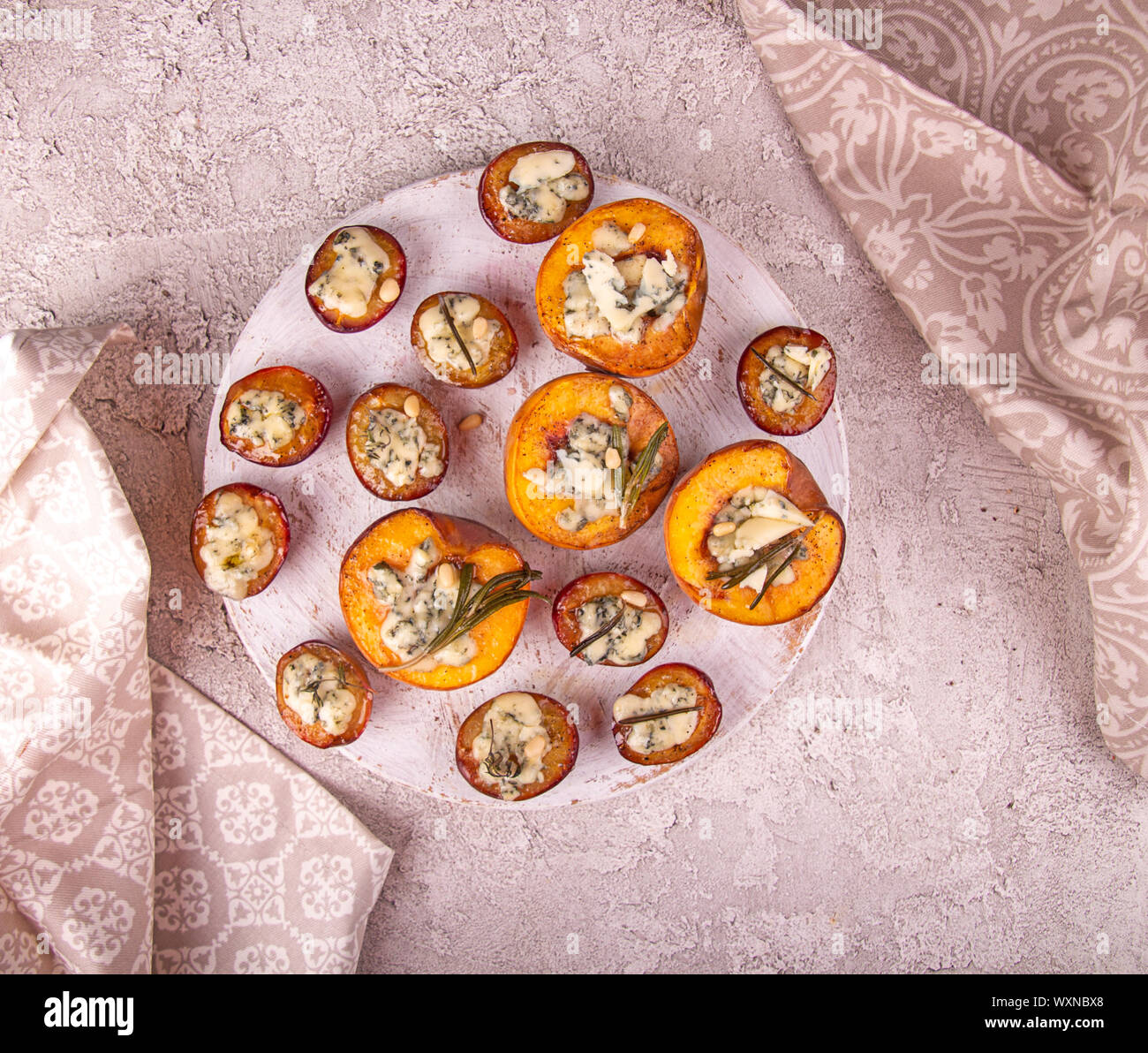 Grilled baked peach and plums stuffed with blue cheese dorblu and ...