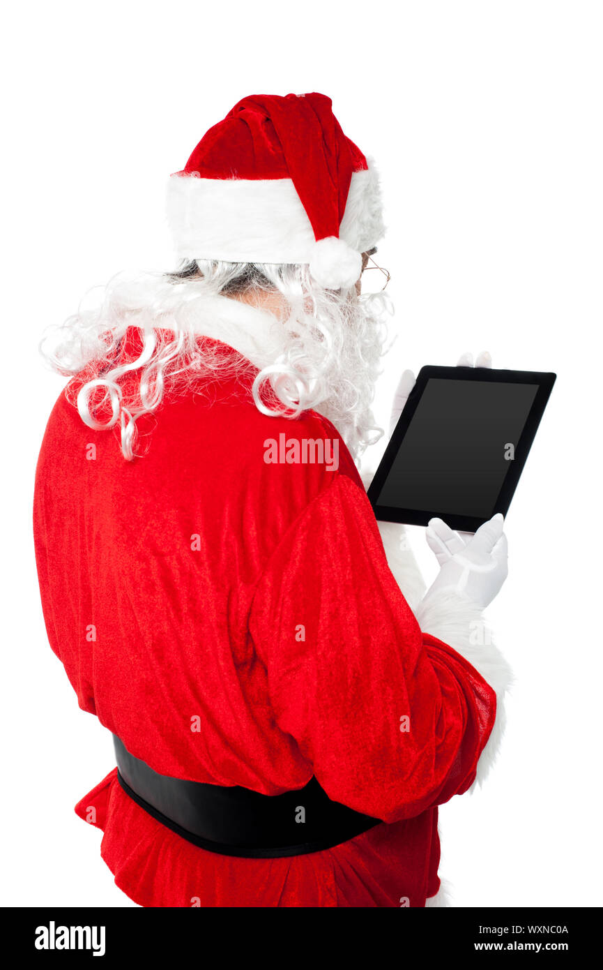 Back pose of santa using touch pad device Stock Photo - Alamy