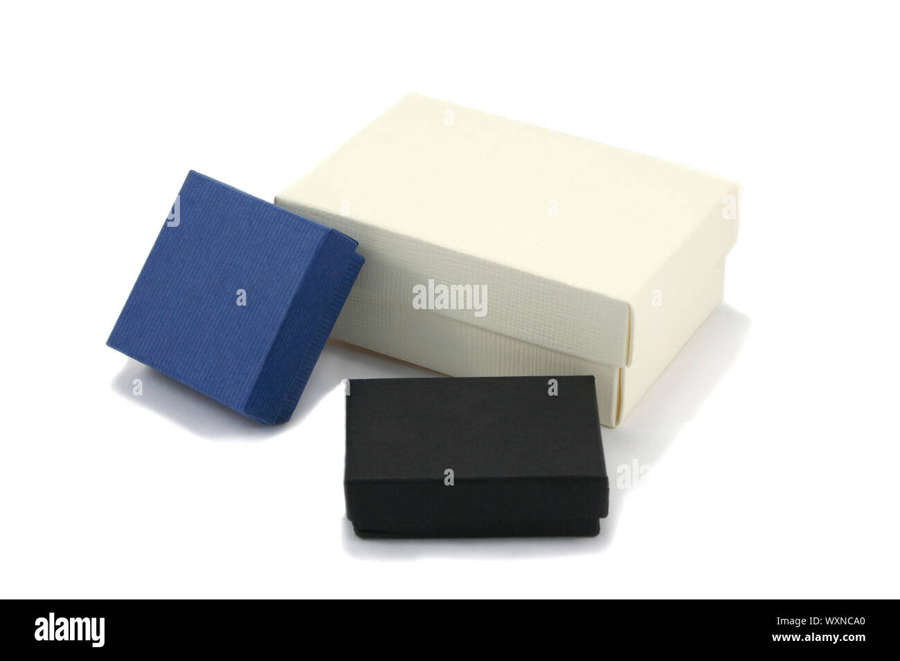 Three gift boxes of various sizes in black, blue and cream coloured ...