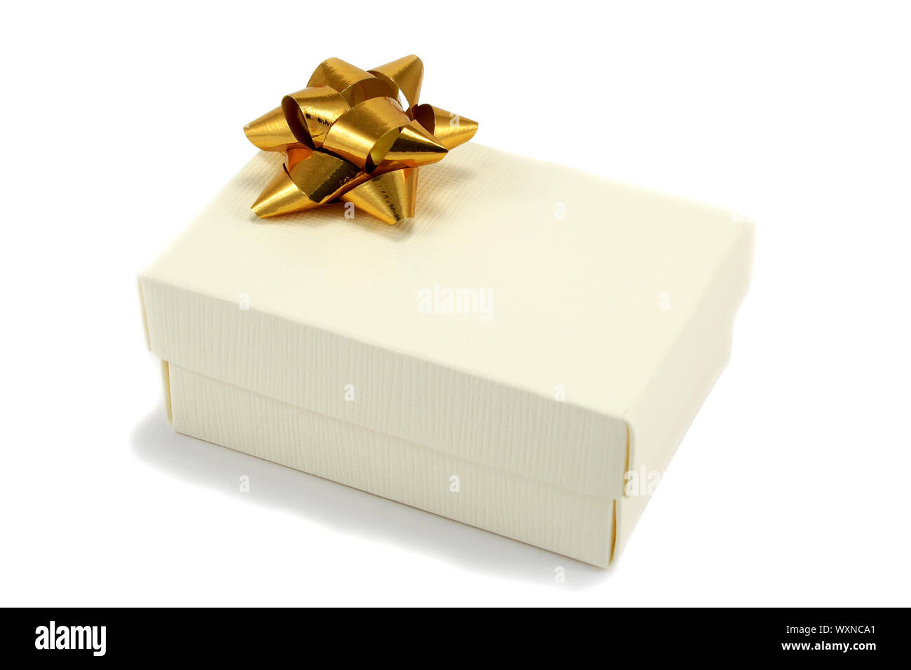 Textured cream cardboard gift box with metallic gold coloured bow ...