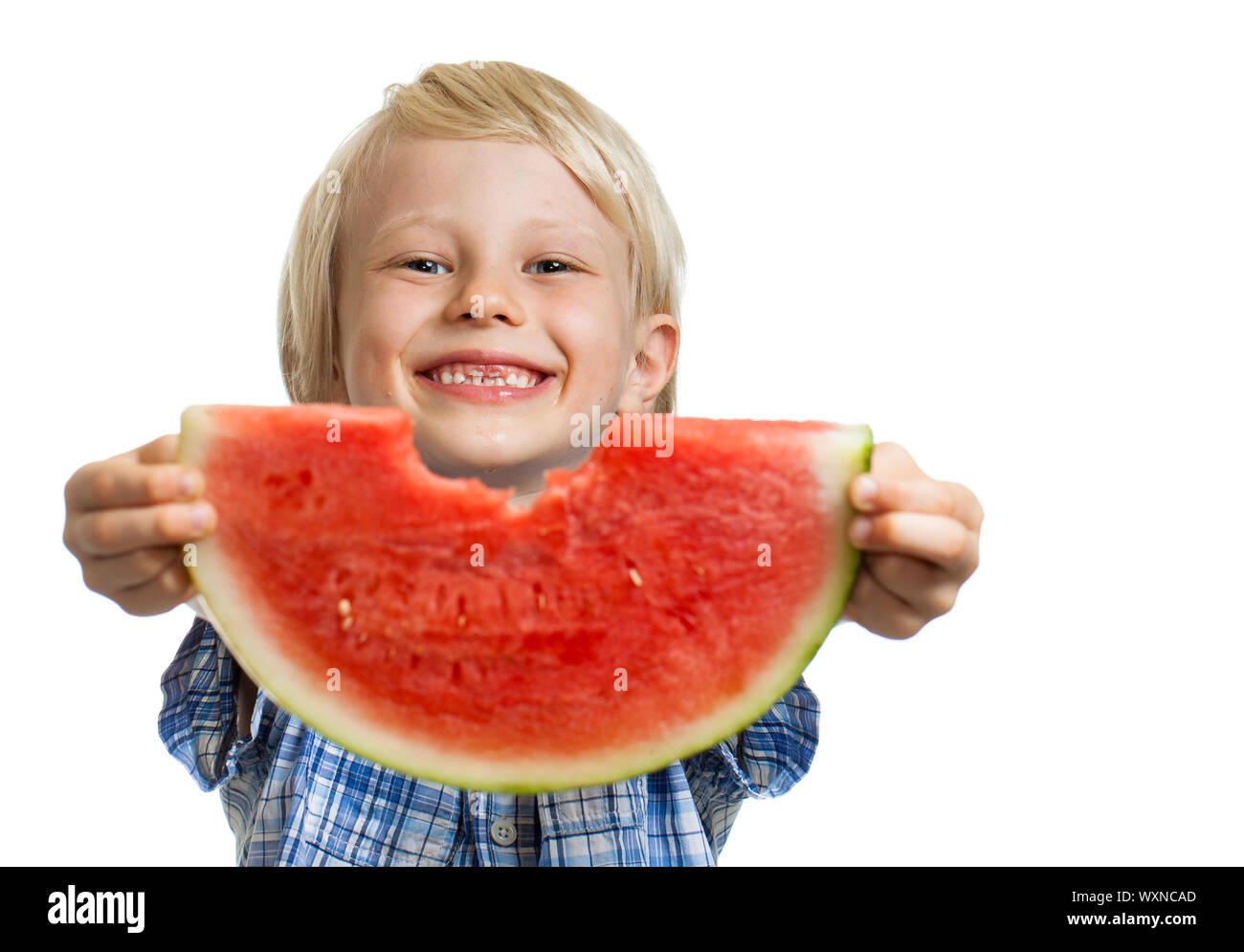 A cute smiling boy holding out and peeking through a bite in a slice ...