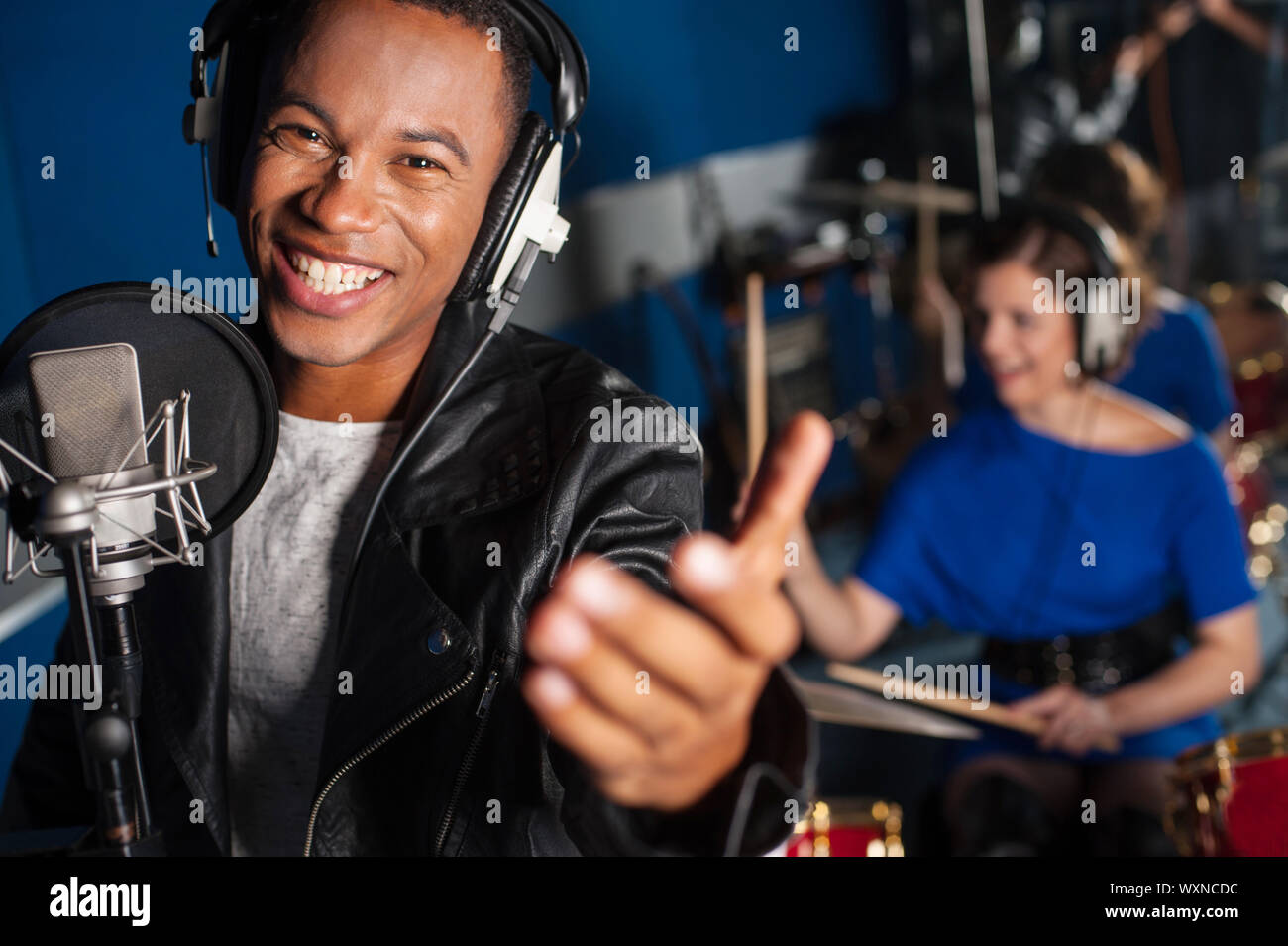 Male singer recording a song in studio Stock Photo - Alamy