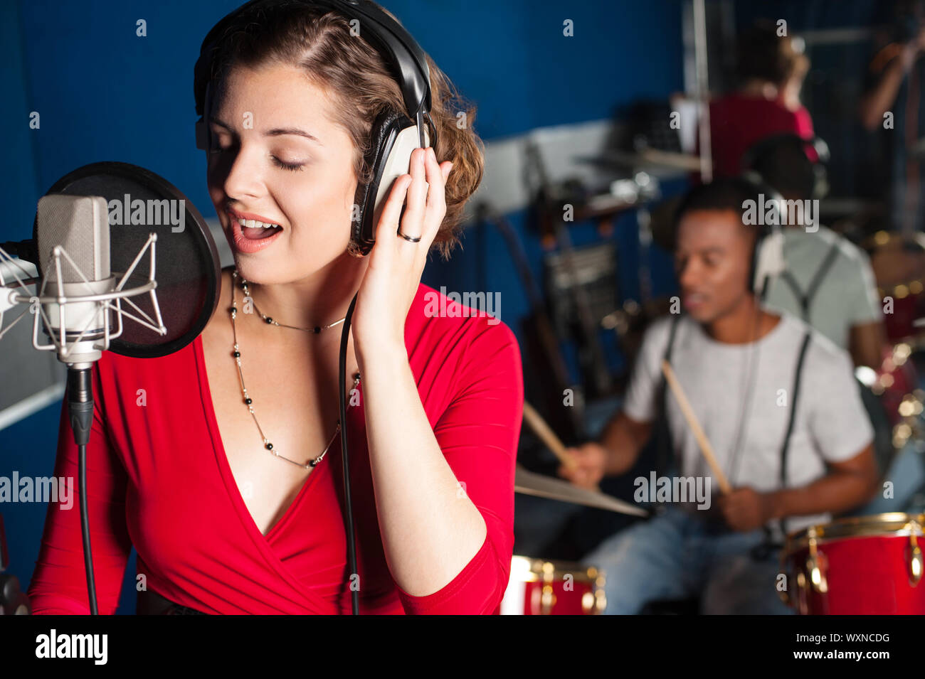 Female playback singer recording a track Stock Photo - Alamy