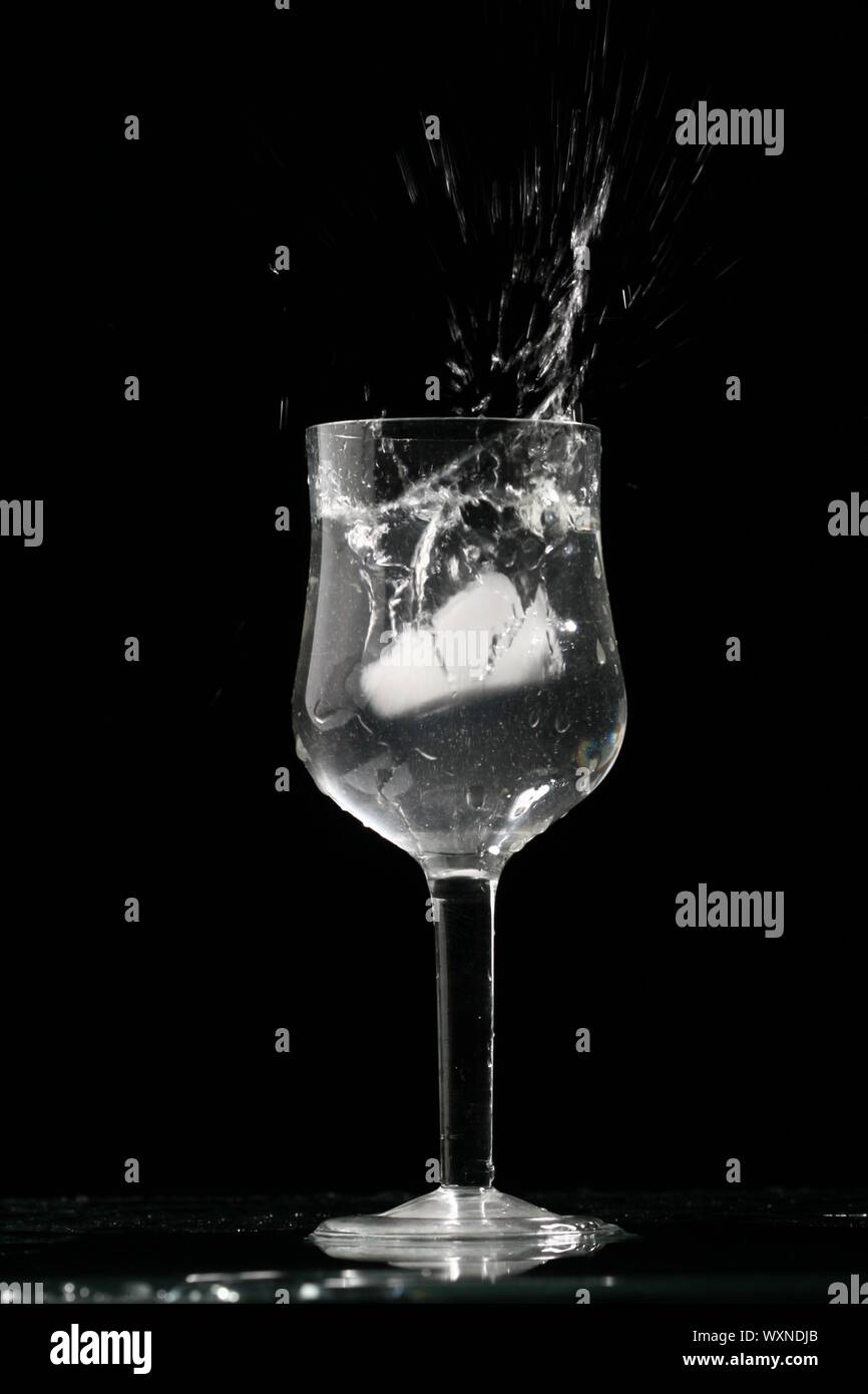 alcohol splash on black background Stock Photo - Alamy