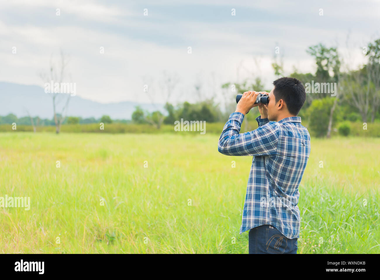 Bird watching in the forest with natural background. Tourist holding ...
