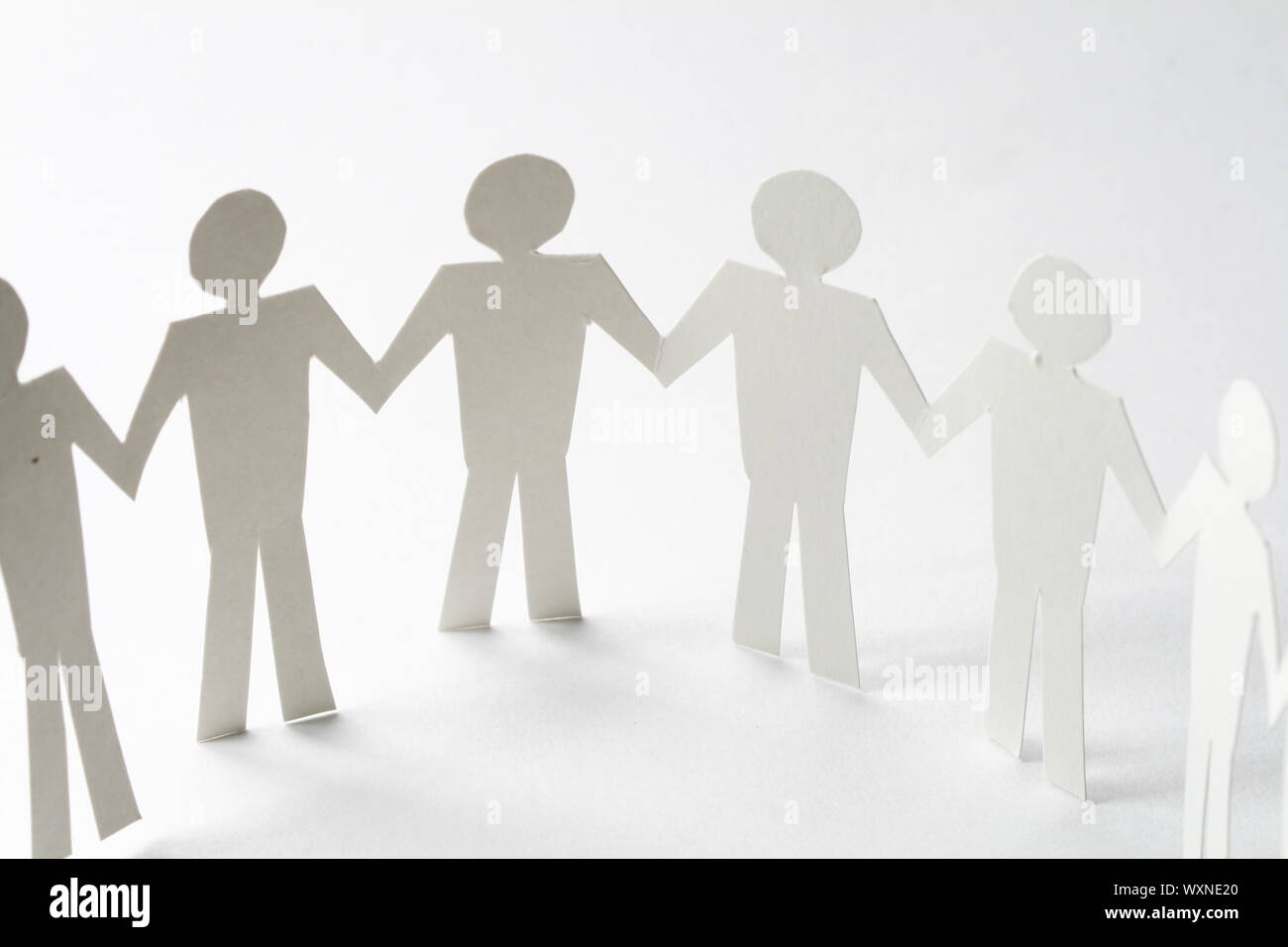 paper team linked together partnership concept Stock Photo - Alamy