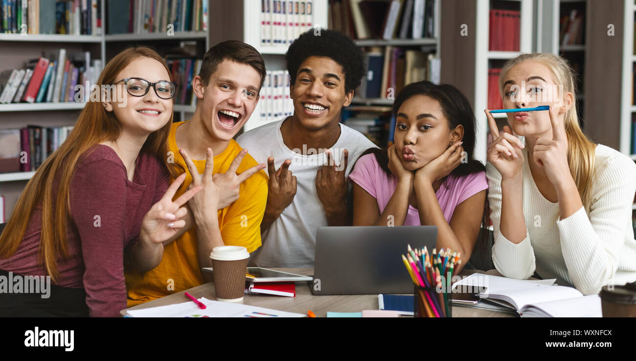 Funny group of students posing at camera in library Stock Photo - Alamy