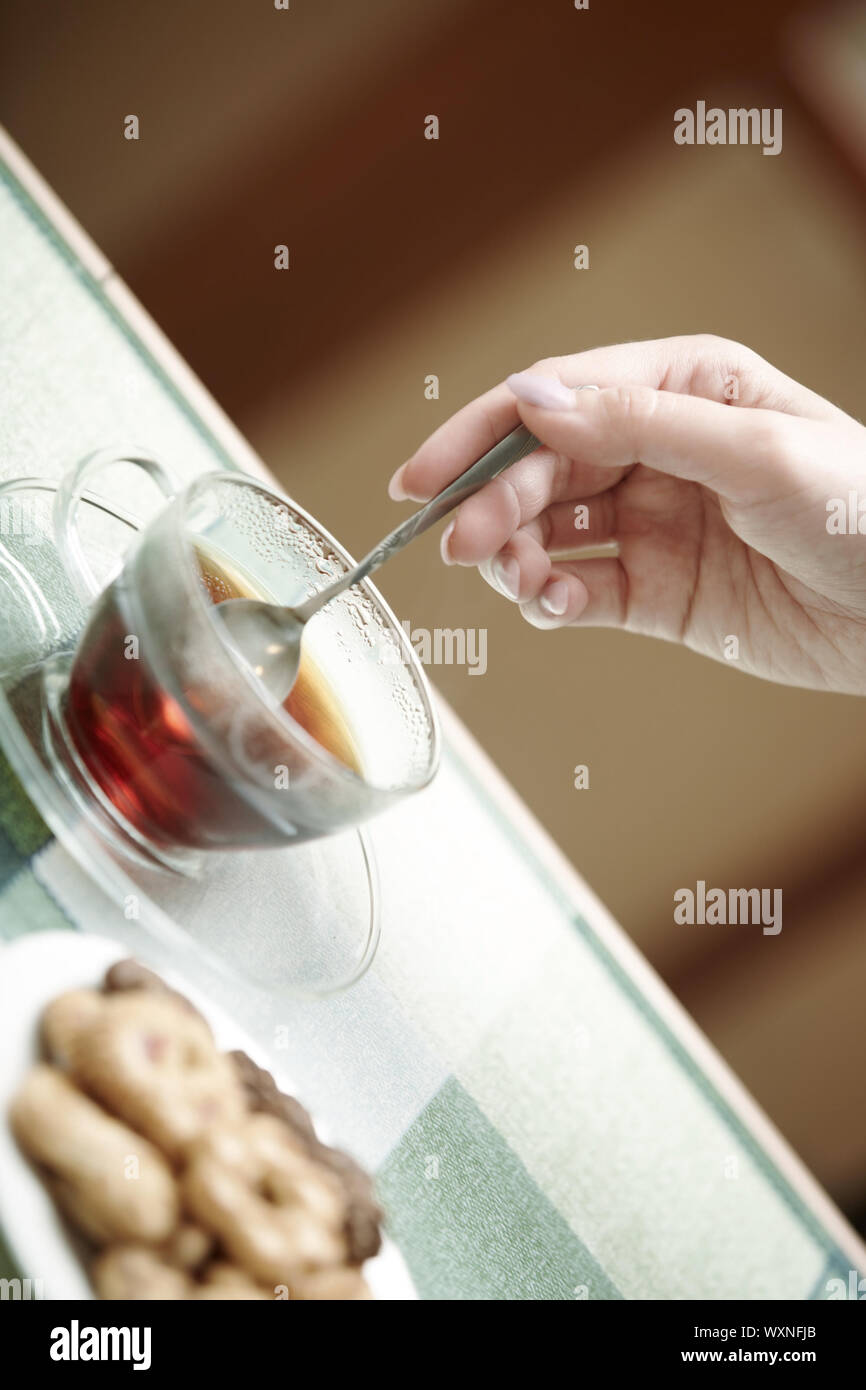 Human hands making tea Stock Photo - Alamy
