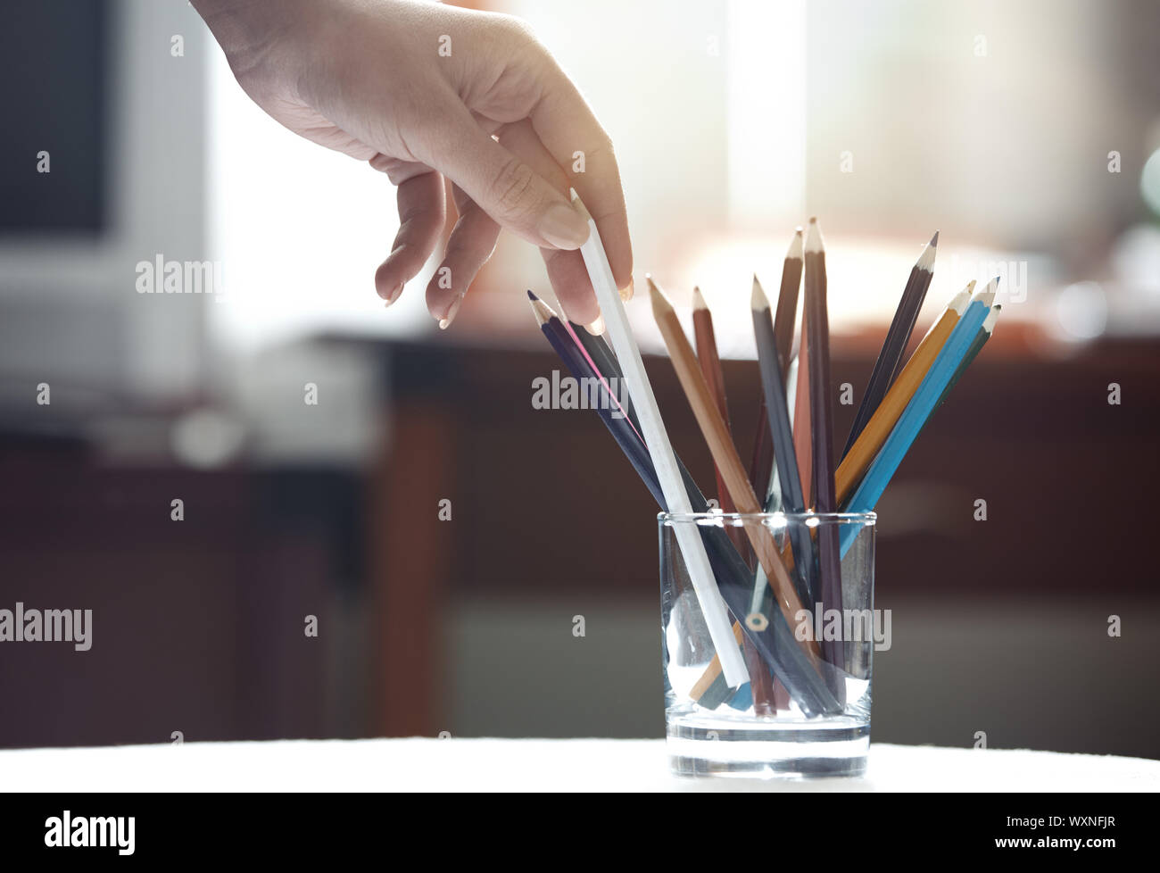 Human hand taking pencil in artist room Stock Photo - Alamy