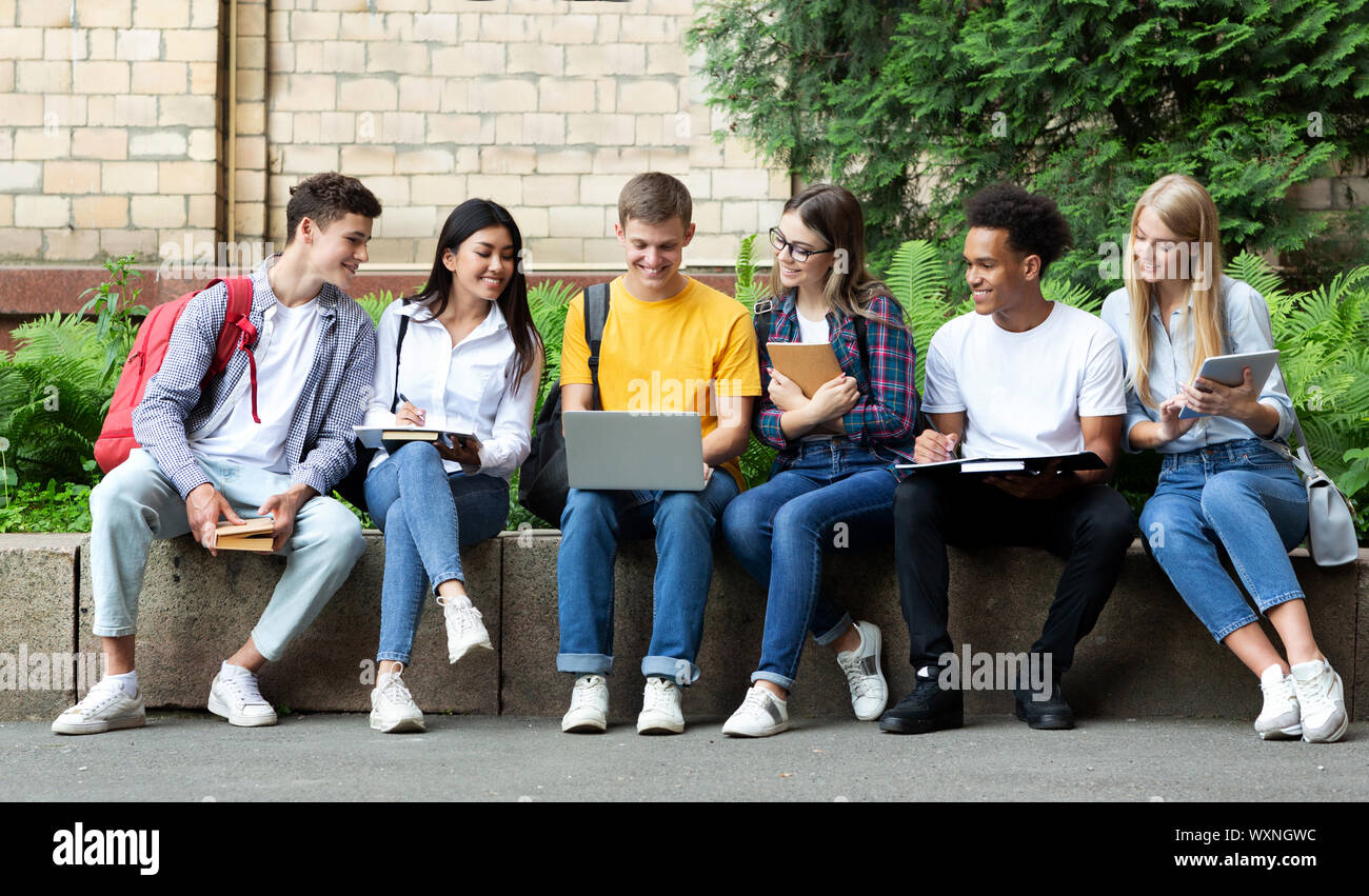 Happy teens preparing for exams in university campus Stock Photo - Alamy