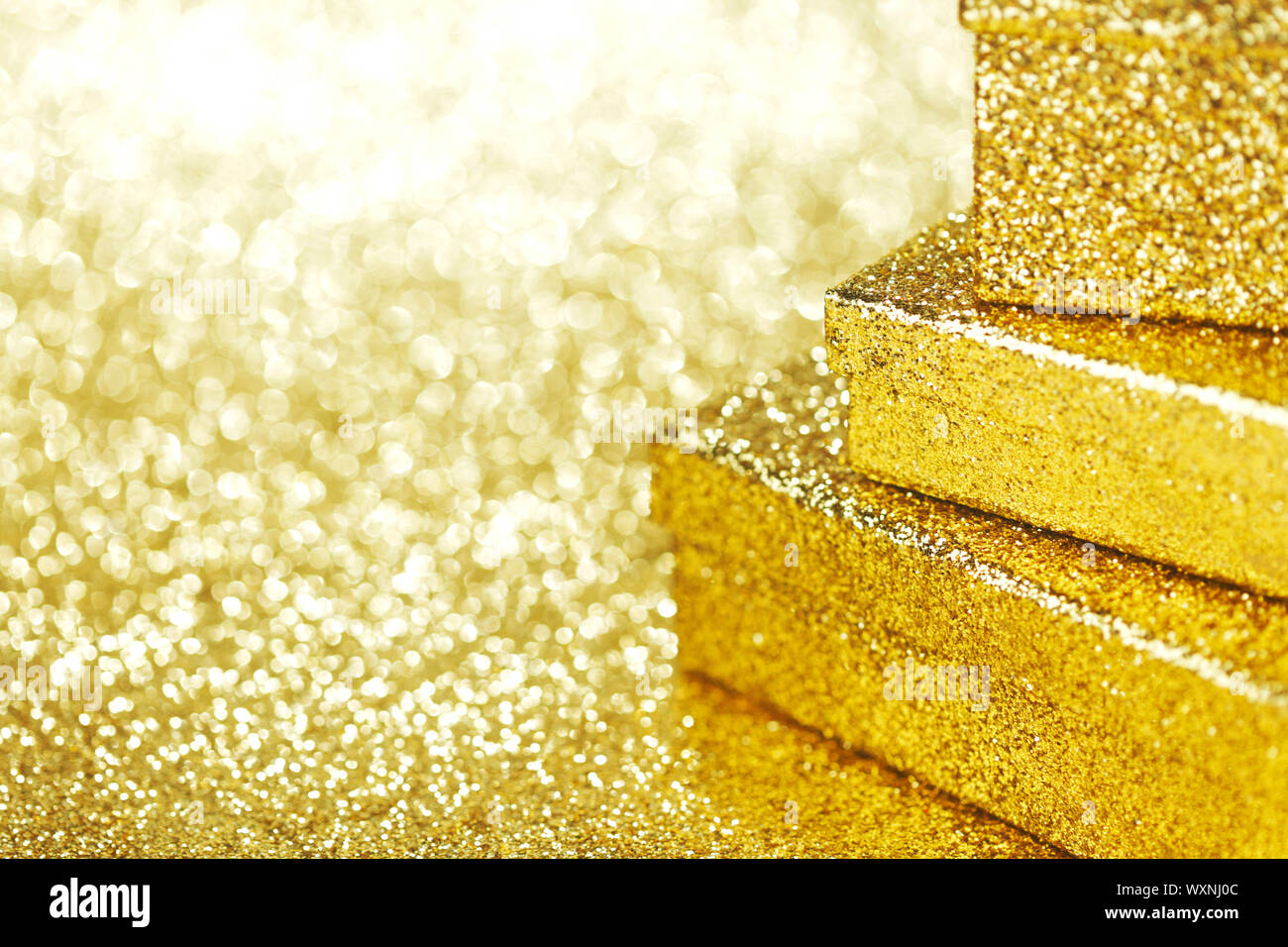 Golden boxes with holiday gifts on shiny glitter background Stock Photo ...
