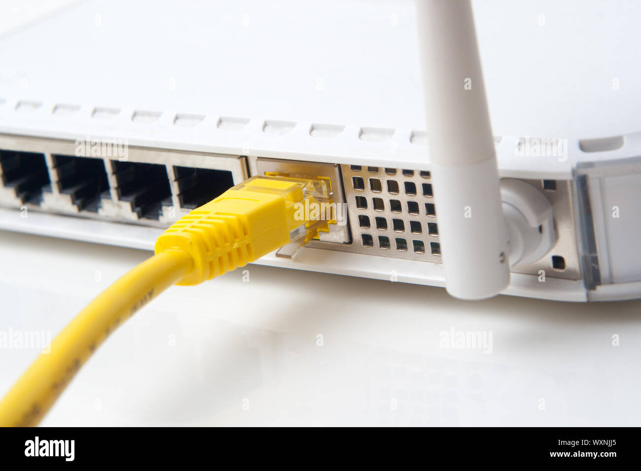 Wireless lan router with yellow network cable Stock Photo - Alamy