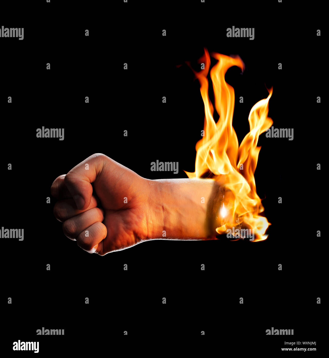 A burning fisted hand on black background Stock Photo - Alamy