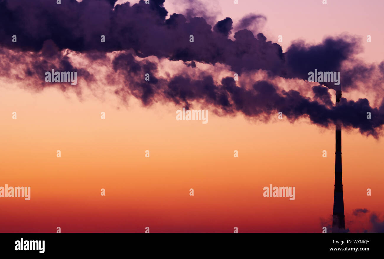 Air polluting smokestack against sunset sky Stock Photo - Alamy