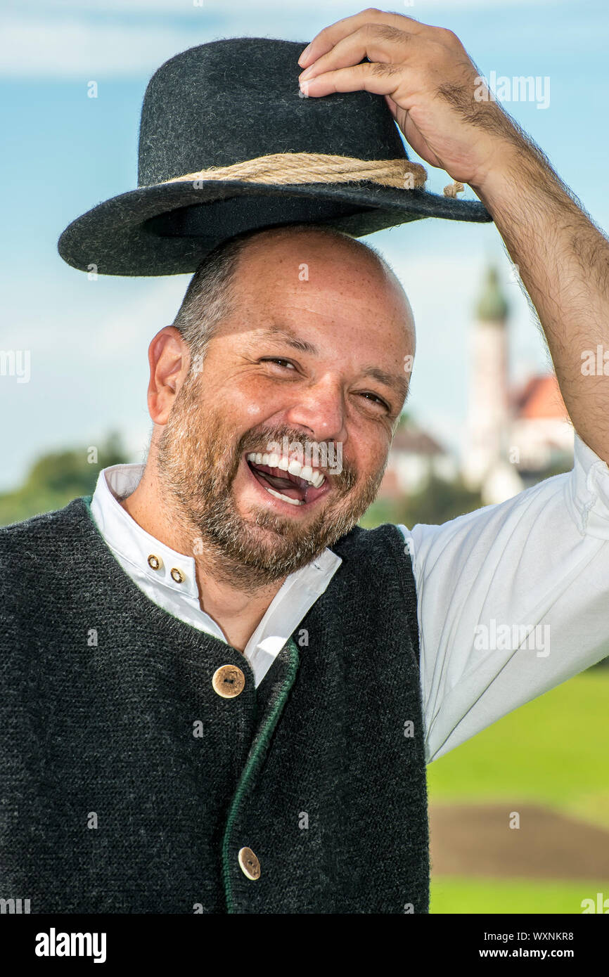 Portrait of a laughing man in traditional bavarian clothes with ...