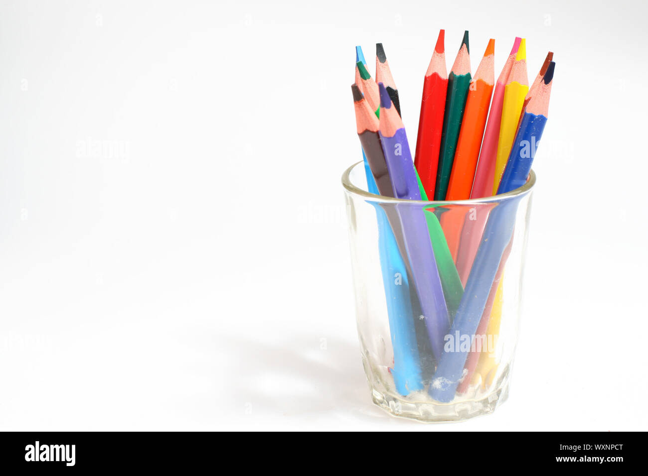 color pencil in glass macro close up on white Stock Photo - Alamy