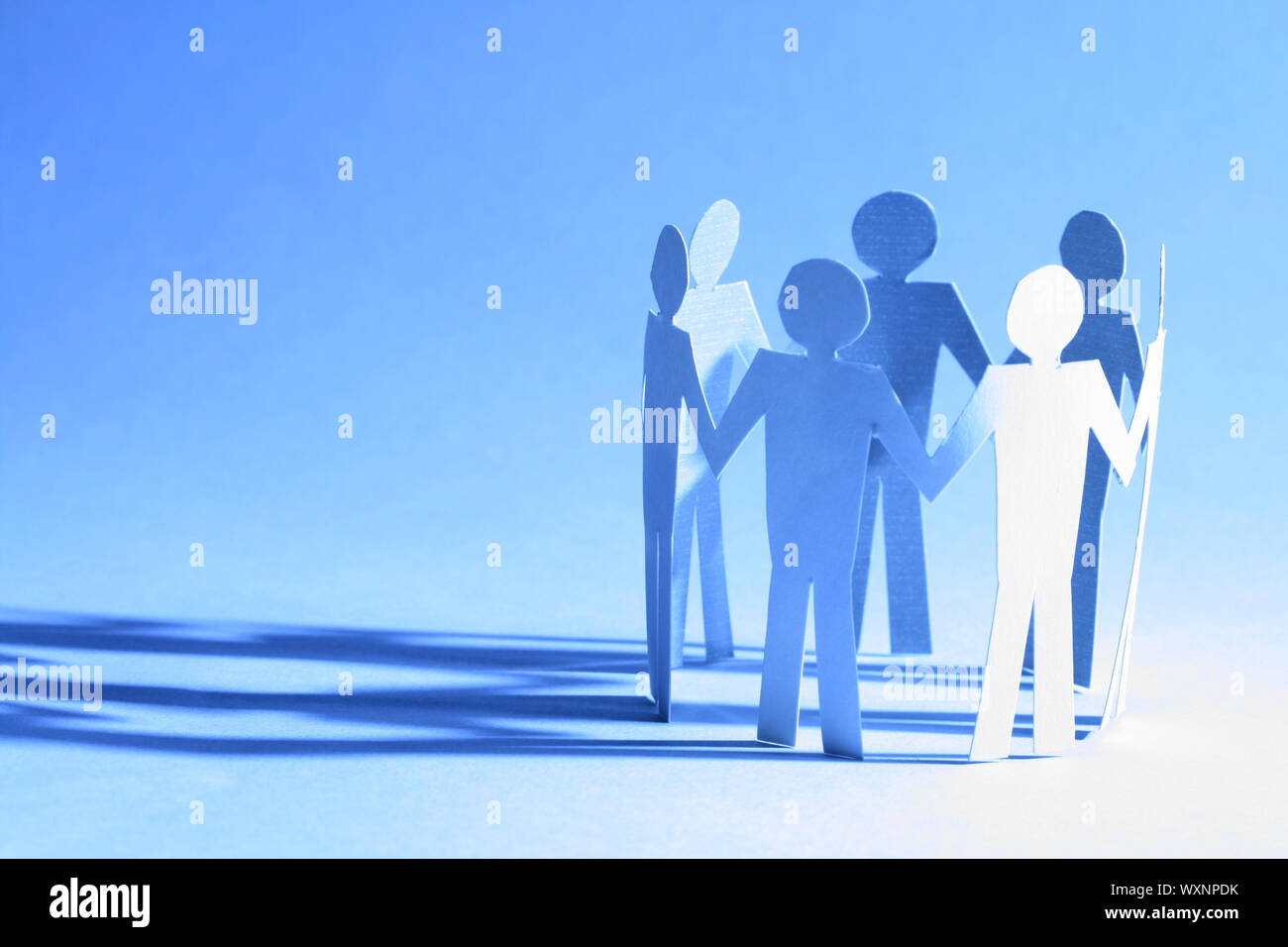 paper team linked together partnership concept Stock Photo - Alamy