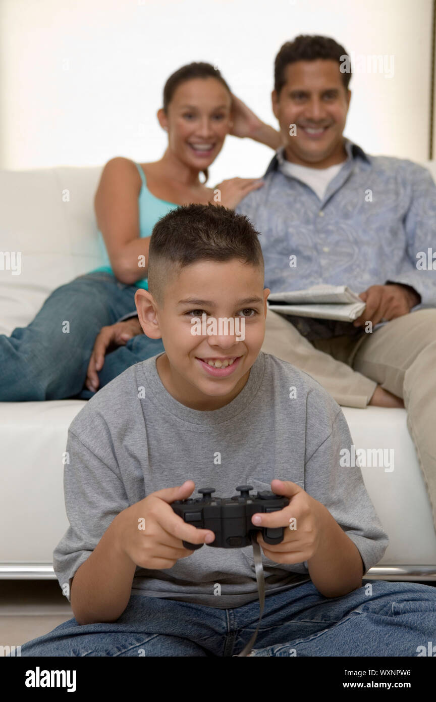 Parents Watching Son Play Video Games Stock Photo - Alamy