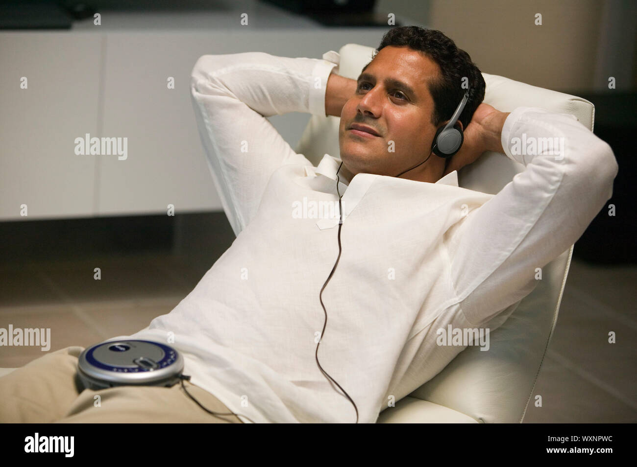 Reclining Man Listening to Music Stock Photo - Alamy