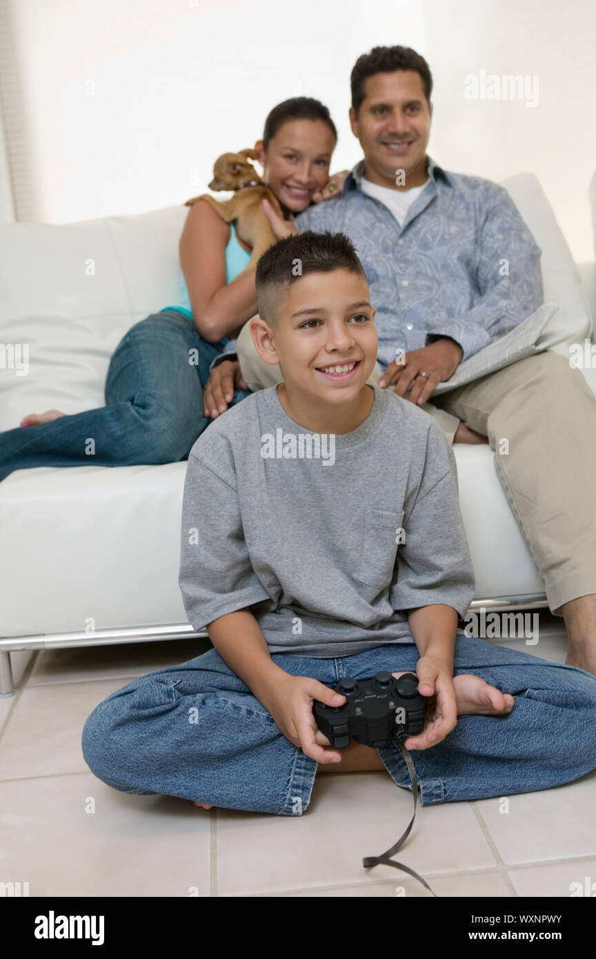 Parents Watching Son Play Video Games Stock Photo - Alamy