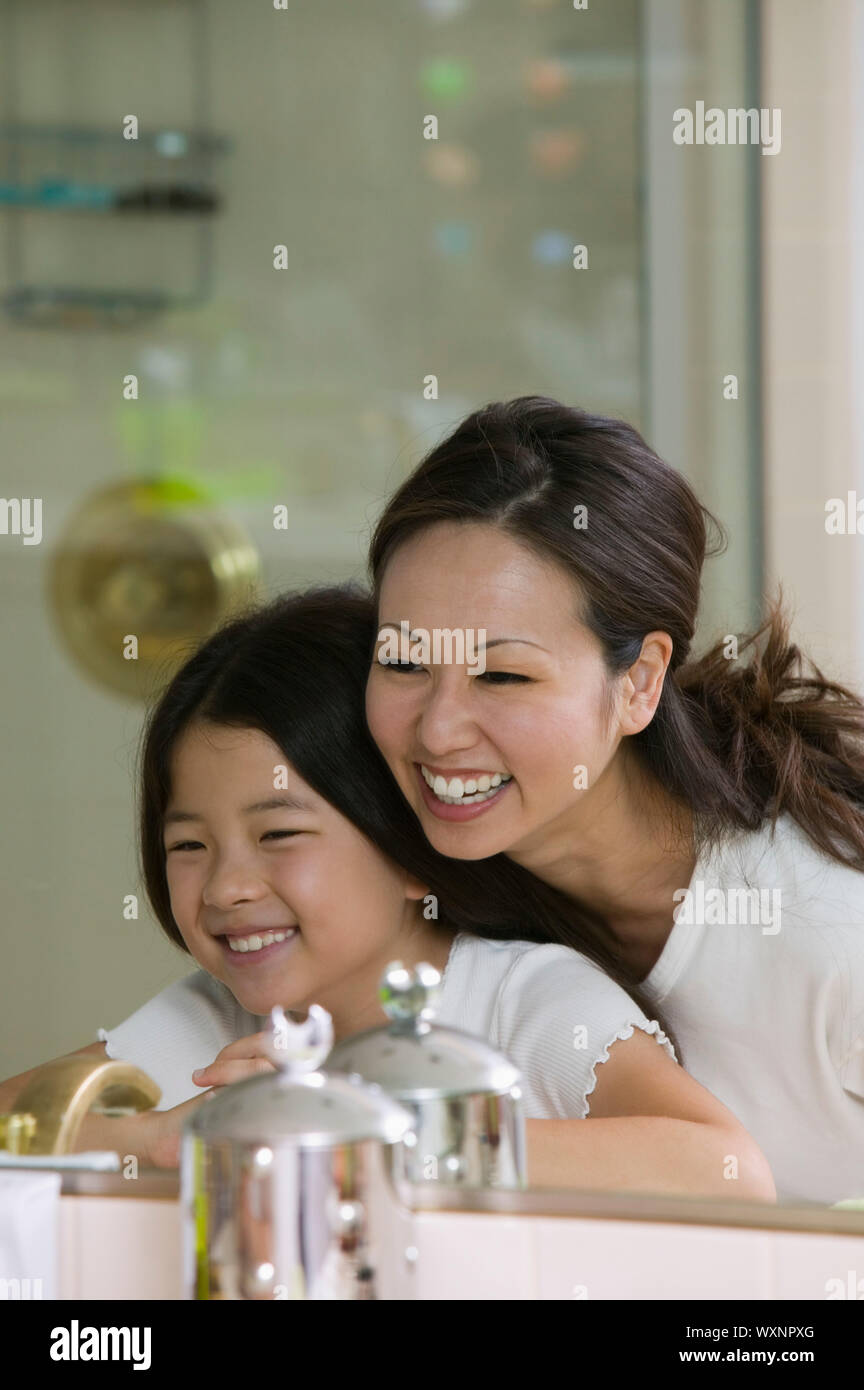 Mother and Daughter Looking in Bathroom Reflection Stock Photo - Alamy