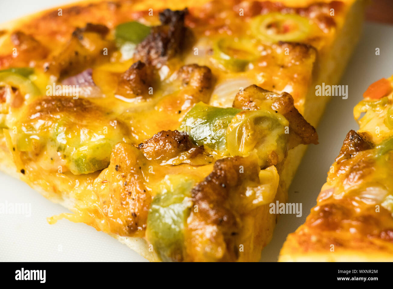Pan Pizza slice on tray with dark brown wood top closeup Stock Photo ...