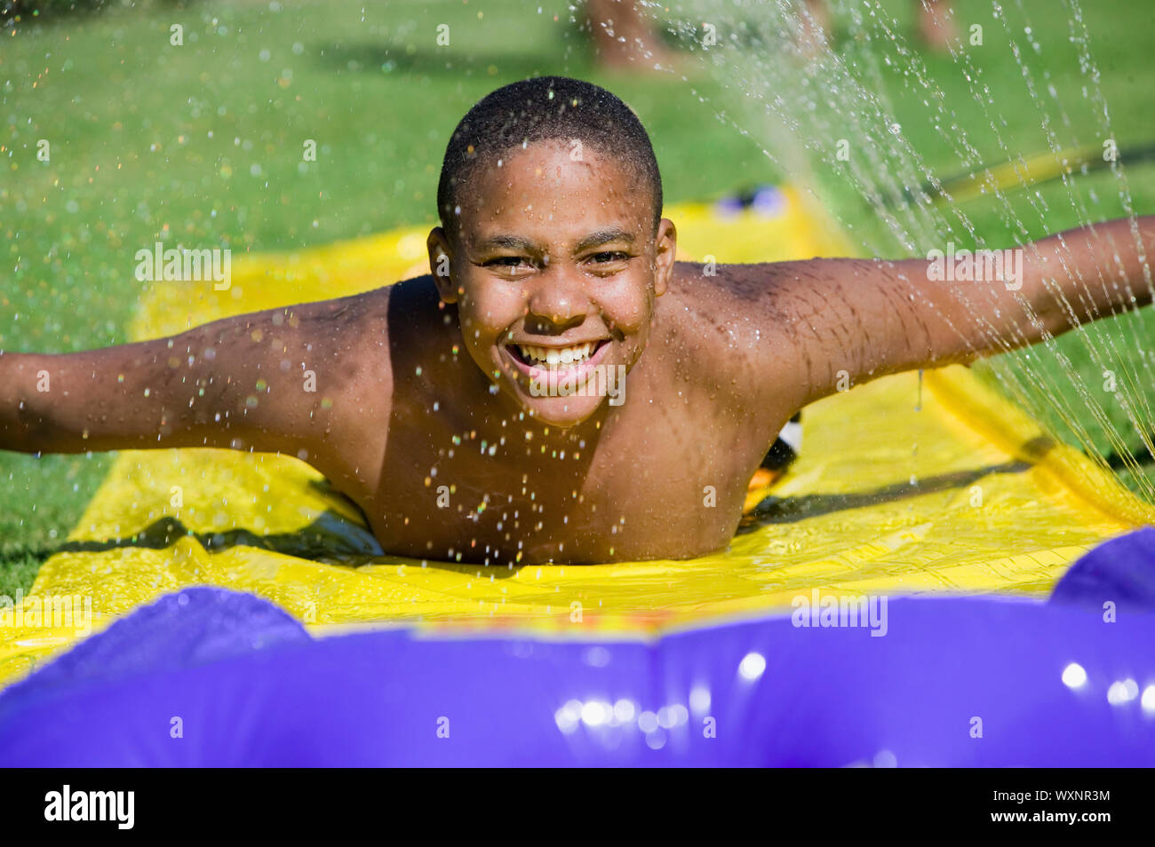 "Boy Sliding on ""Slip 'N Slide Stock Photo - Alamy