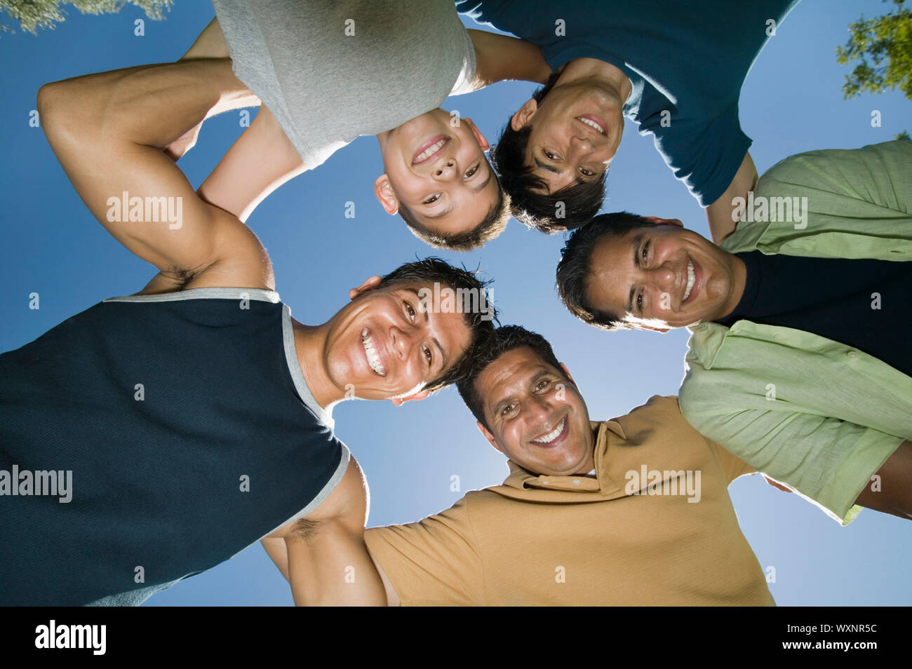 Men in a Huddle Stock Photo - Alamy
