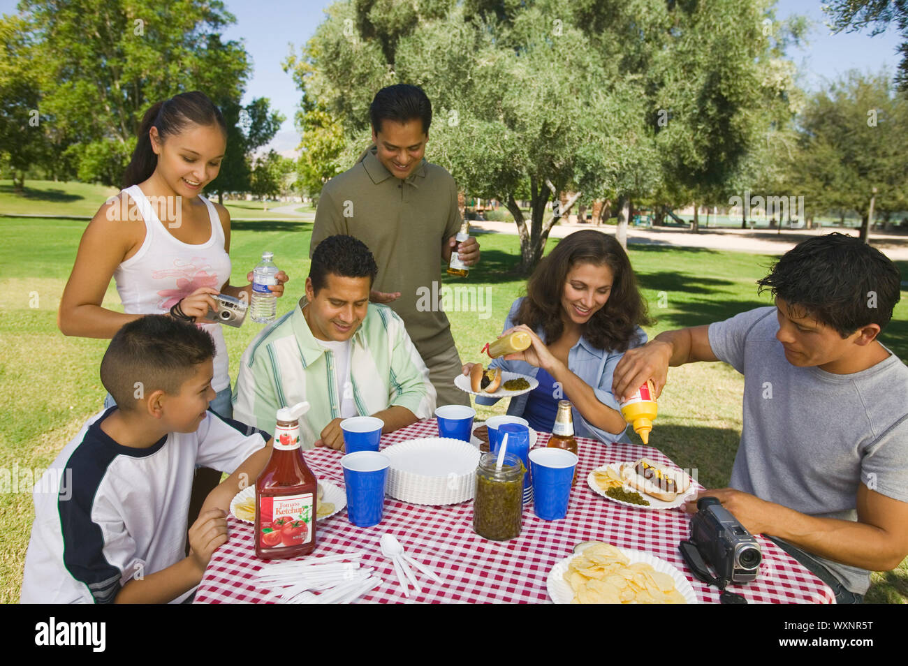 Family gathered around table outdoors hi-res stock photography and ...