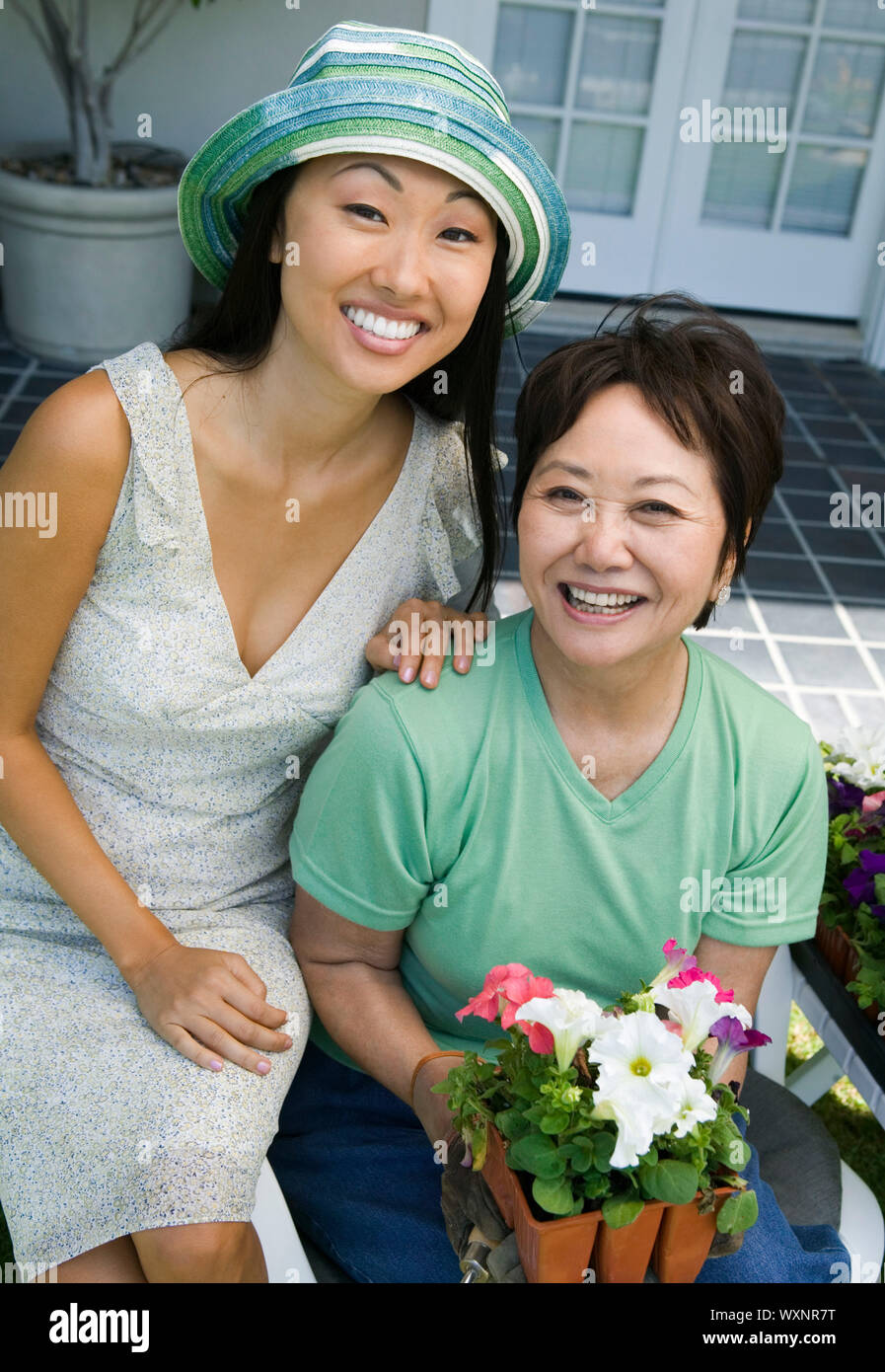 Mother and Daughter Planting Flowers Together Stock Photo - Alamy