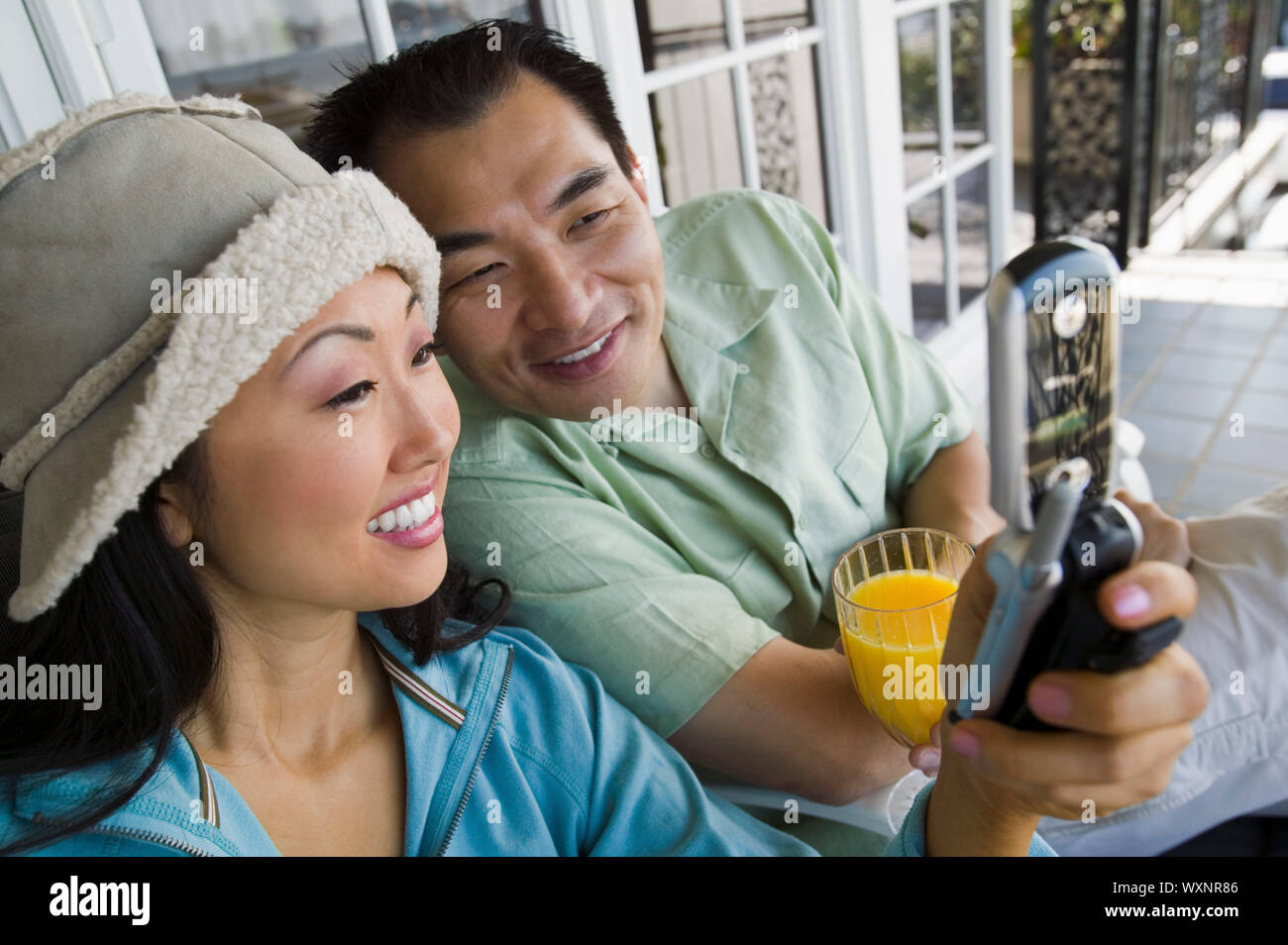 Couple Using Cell Phone Stock Photo - Alamy