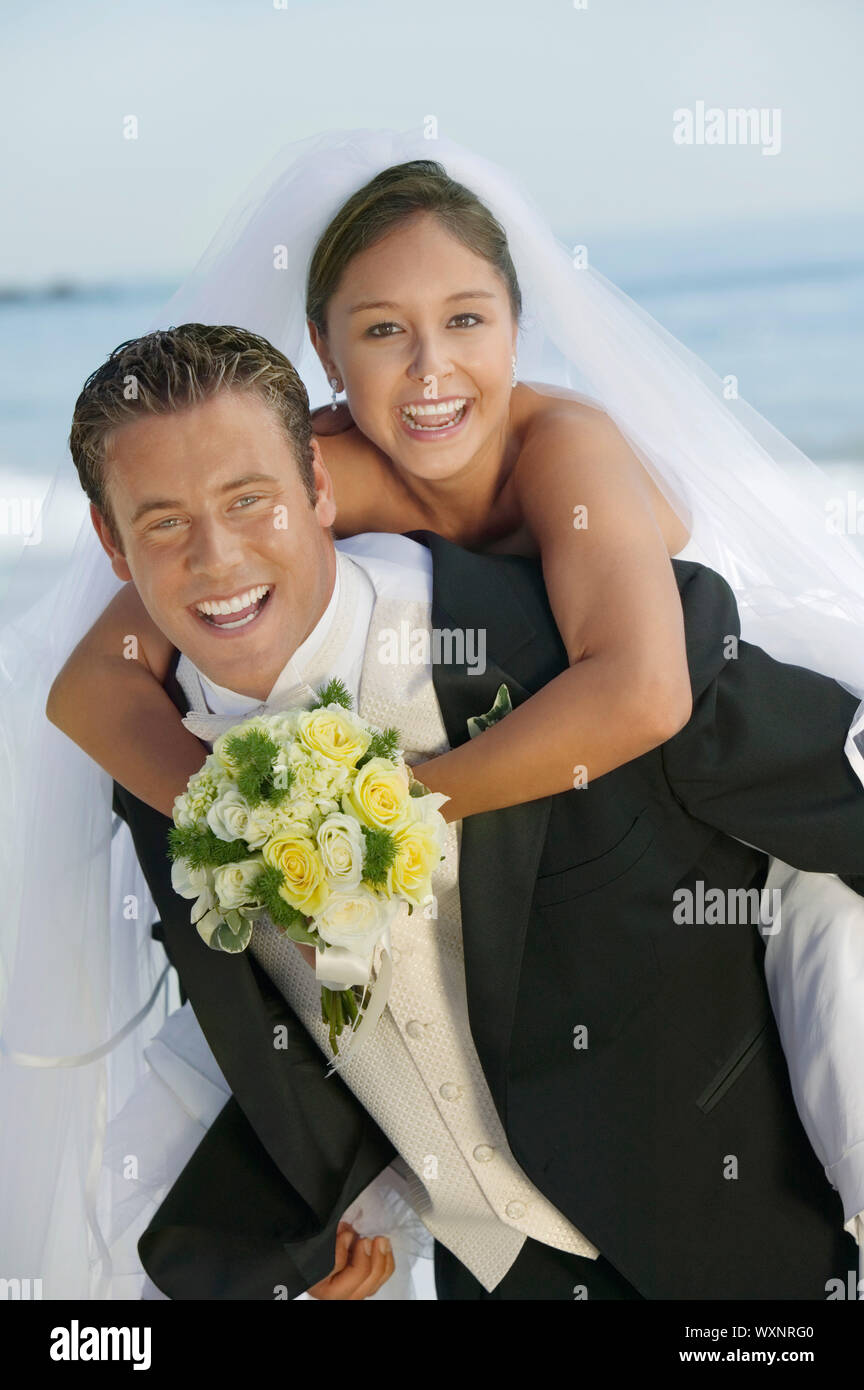 Groom Giving Bride a Piggyback Ride Stock Photo - Alamy