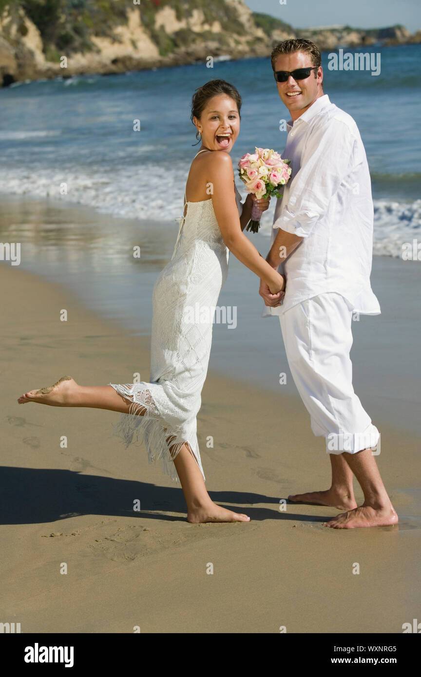Excited Bride and Groom on Beach Stock Photo - Alamy