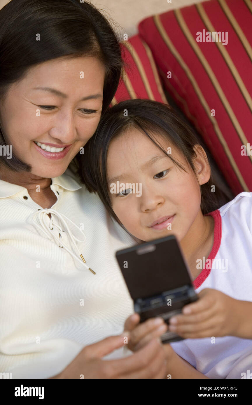 Kids playing handheld video game hi-res stock photography and images ...