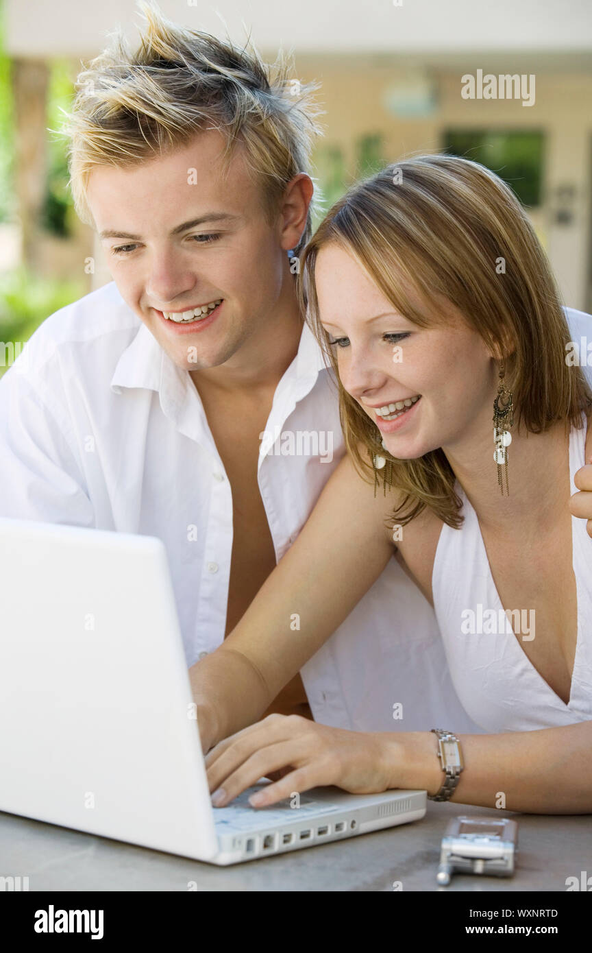Couple Using Laptop Together Stock Photo - Alamy