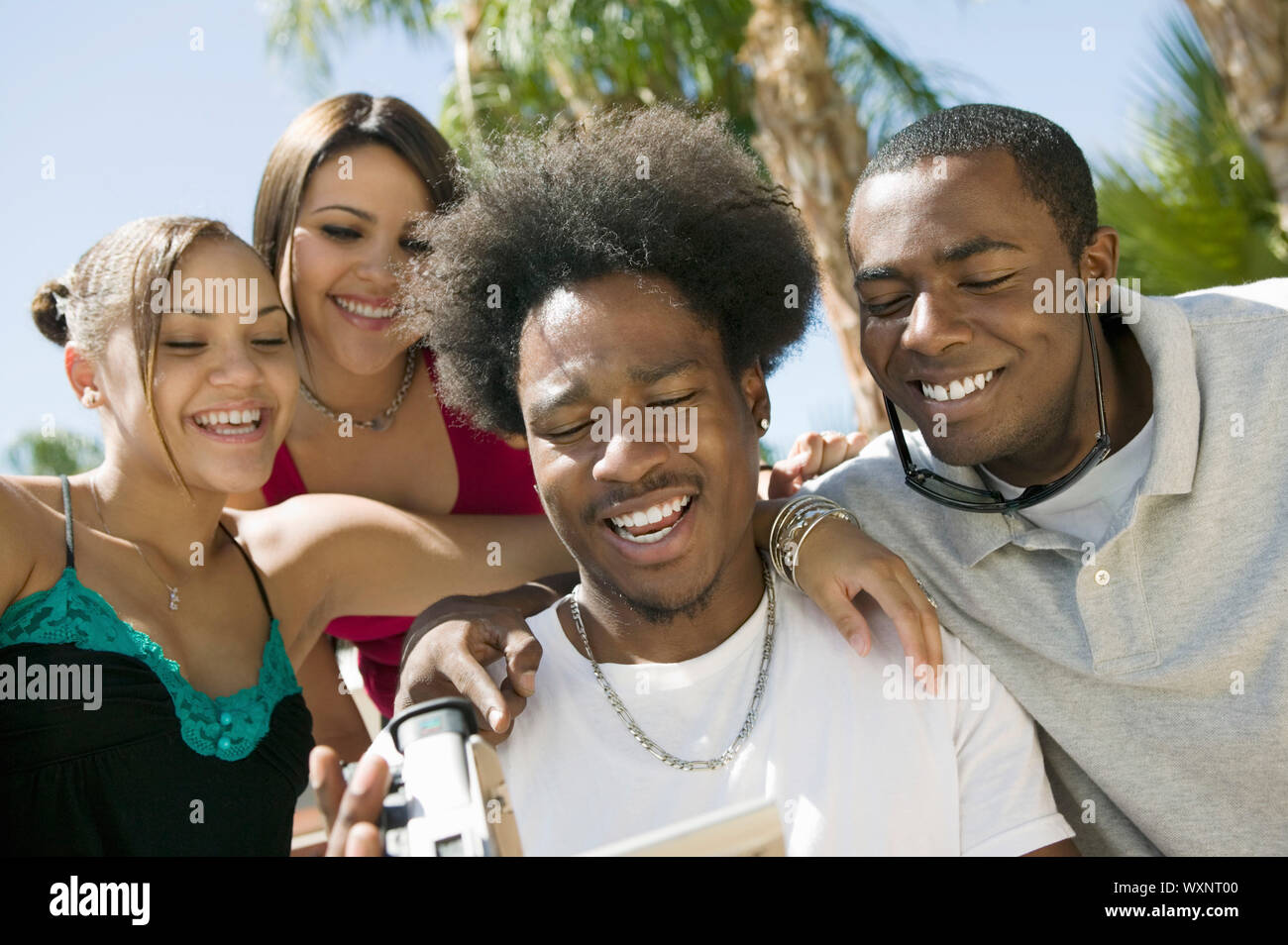 Friends Watching Video Camera Stock Photo - Alamy